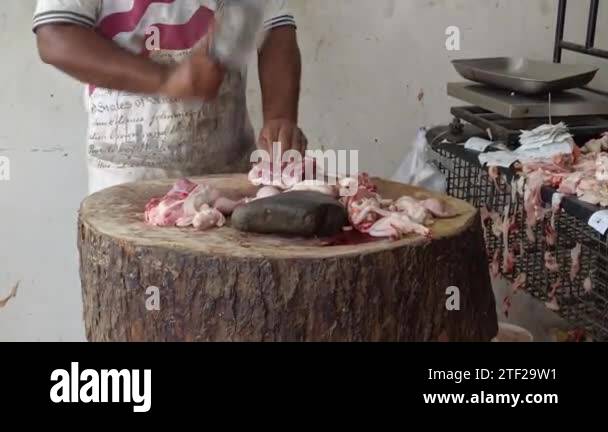 Butcher cutting piece of mutton for waiting customers. Lamp meat ...
