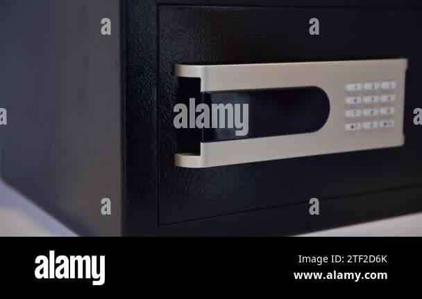 4K Close-up of hand opening metal safe box with pass code in the hotel ...