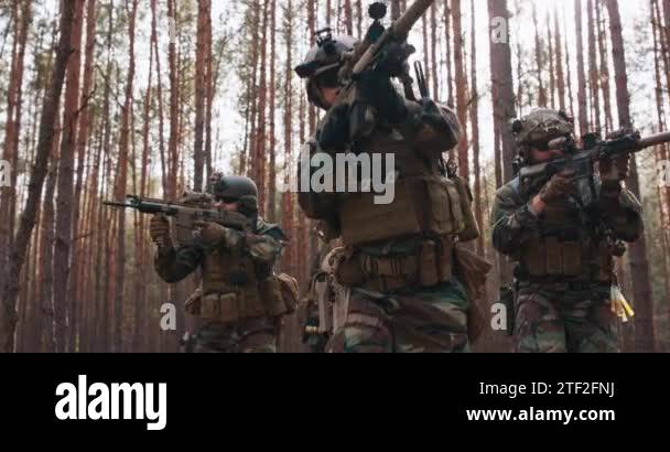 Four Fully Equipped Middle - Aged Soldiers Wearing Camouflage Uniform ...