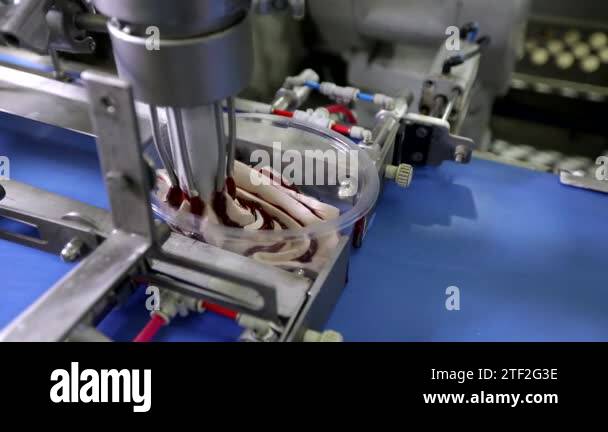 Industrial robot making ice cream. Robotic production. Ice cream ...