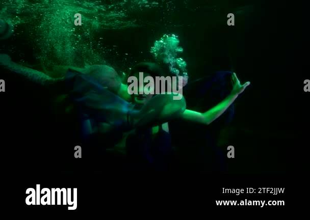 underwater mystery and magic, woman and mermaid are floating in ...