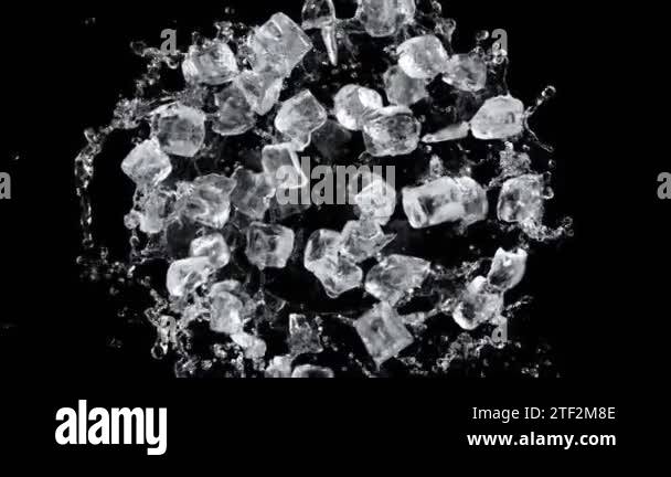 Super slow motion of rotating ice cubes with splashing water, top view ...
