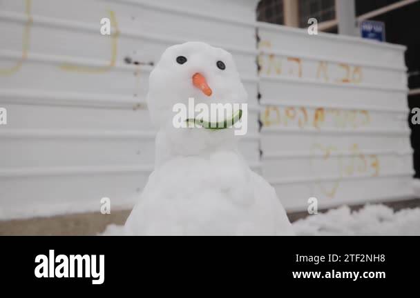 Funny snowman with a carrot nose and buttons instead of eyes and ...