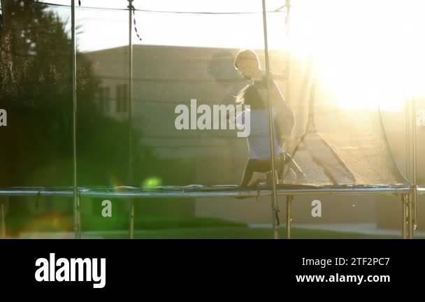 Kids bouncing in trampoline outdoors child falling down bumping and ...