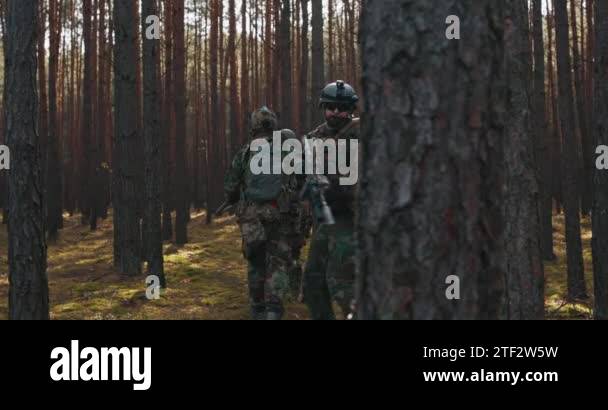 Squad of soldiers during military operation fully equipped camouflage ...