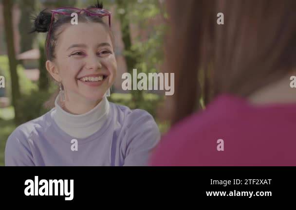 Girls blowing bubbles from chewing gum. Girls play with chewing gum on ...