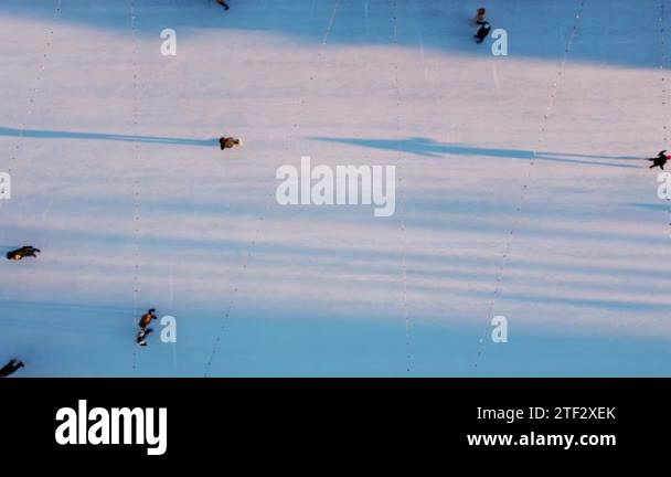 People skating on an open-air ice skating rink in the city in the ...