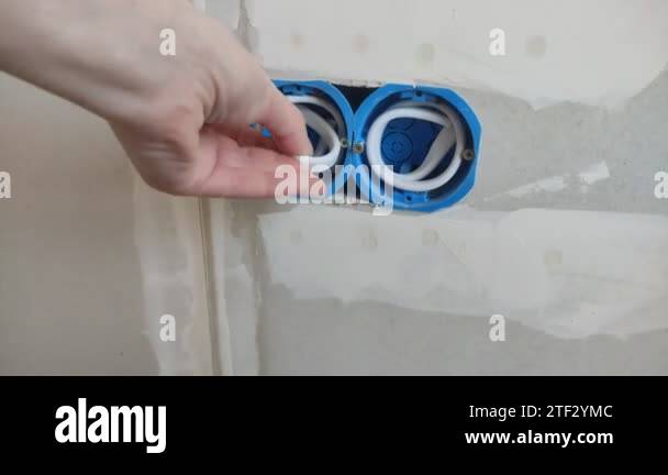Installation of an electrical outlet in a plasterboard wall Stock Video ...