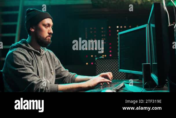 Male hacker using keyboard to type a dangerous malware into bank system Hacker Breaks into Stock ...