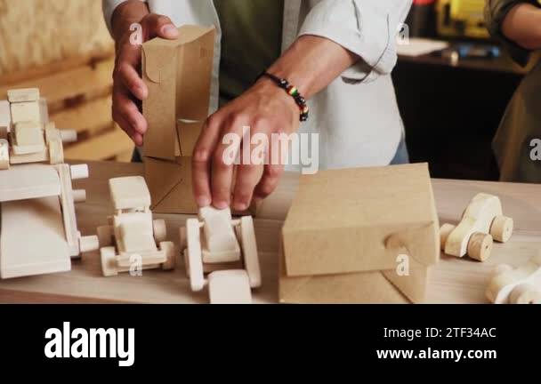 Two people in a carpentry workshop packing and shipping product sin ...