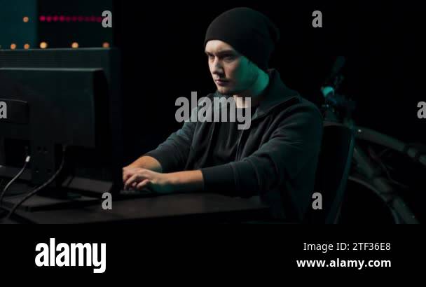 Young Professional Male Hacker Using Keyboard Typing Bad Data Into 8583