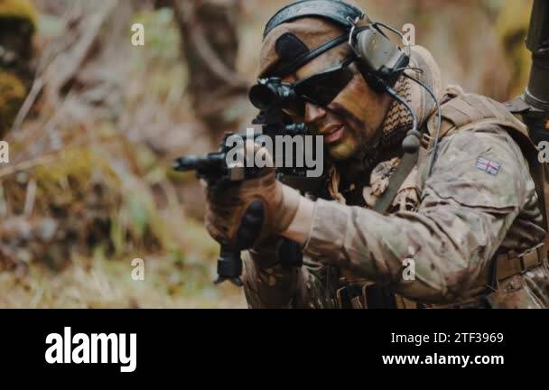 British Army Ranger on the war zone peace mission aiming an automatic ...