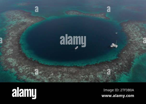 Aerial view luxury yachts inside Great Blue Hole giant marine sinkhole ...