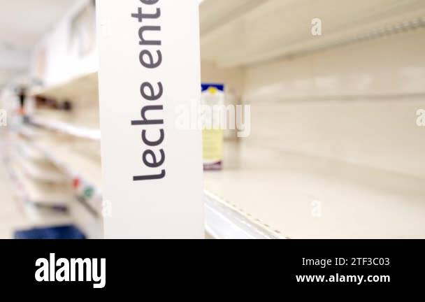 4K video of Milk empty shelf in the supermarket in Spain. Leche entera ...