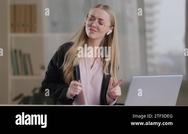Excited happy caucasian businesswoman wear wireless headphones having ...