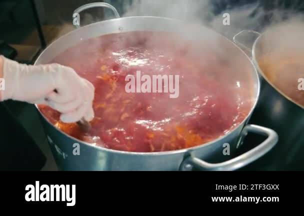 Preparation of Ukrainian traditional red beet borsch dish. The chef ...
