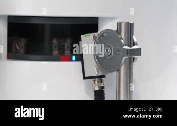 Fixed sensor checking or counting parts which moving past the small ...