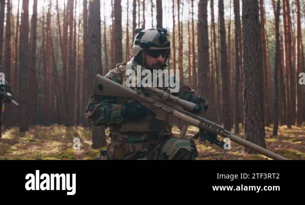 The commander of fully equipped soldiers in camouflage uniforms orders ...