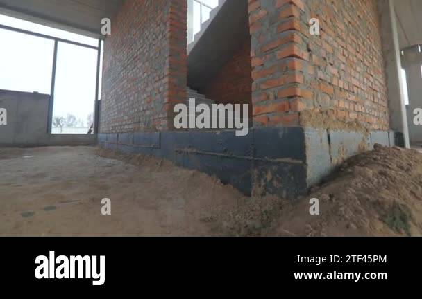 Inside the house that is being built. Unfinished house. Staircase in an ...