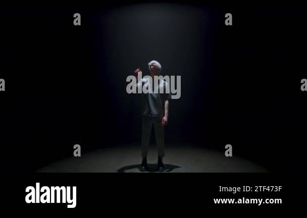 Vr teenager touching air in dark room. Futuristic guy experience cyber ...