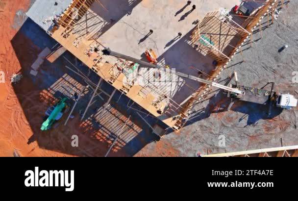 Crane holds timber roof frame of wooden rafters beams an interior view ...