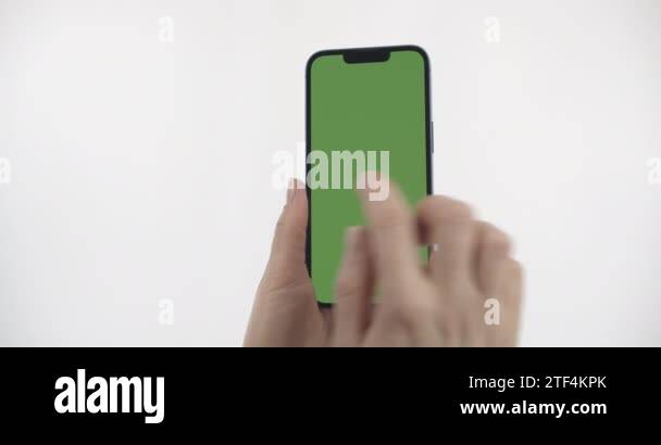 Woman Holds Smartphone with Green Screen, Swipes Right and Tap Screen ...