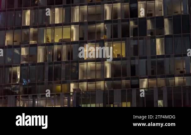 Night aerial view of office or apartment building glass window facade ...