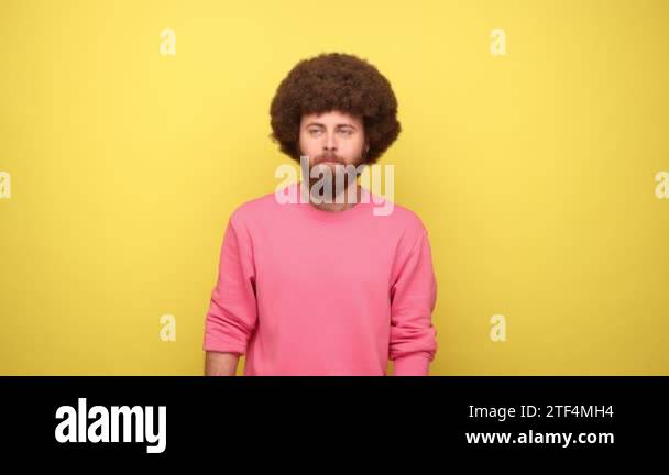 Man with Afro hairstyle with positive expression dabbing raising hands ...