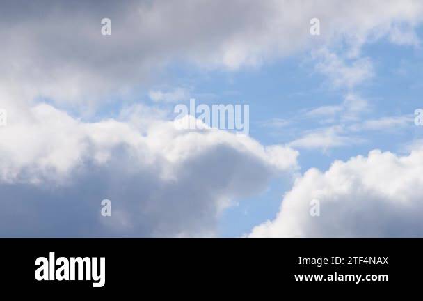 Two layers of clouds, dynamic bright cumulus and altostratus clouds ...