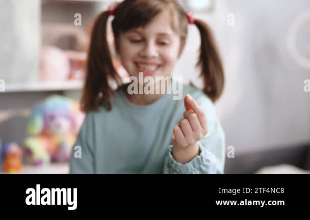 Portrait of a baby girl with a toothless smile. Shows a ripped tooth ...