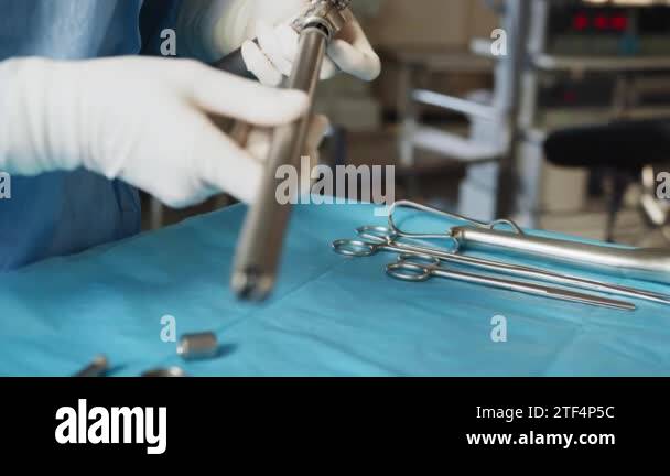 Surgical medical instruments on the table. Scrub nurse prepares medical ...