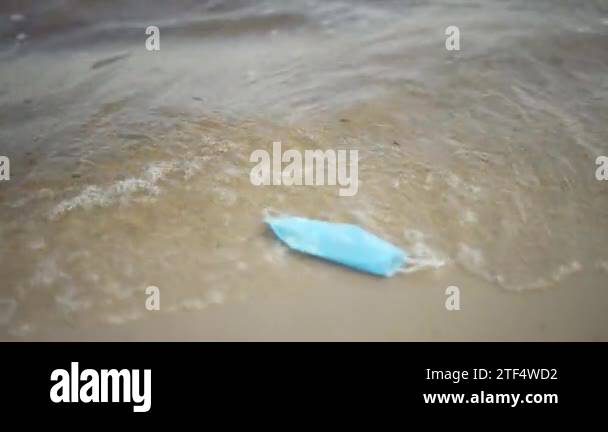 Live camera follows coronavirus face mask swimming in waves rolling on ...