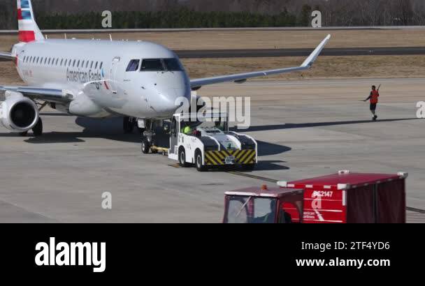 Preparation and towing the American Airlines aircraft from the terminal ...