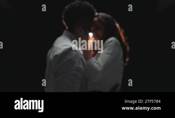 Couple of different nationalities in love, in tender passion, embrace ...