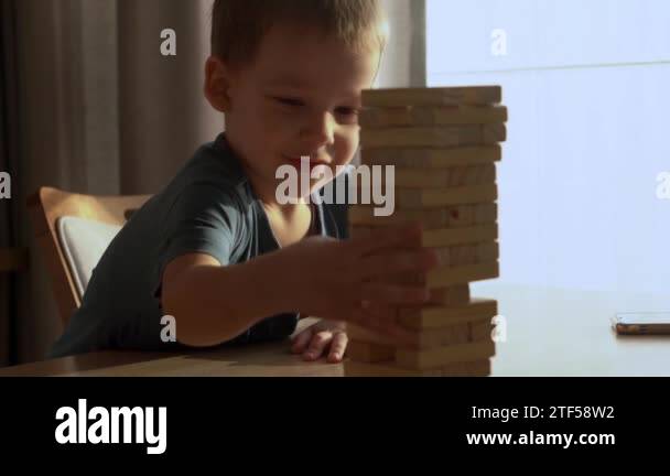 Small Kids Children playing tiny jenga with her parents at table, jenga ...