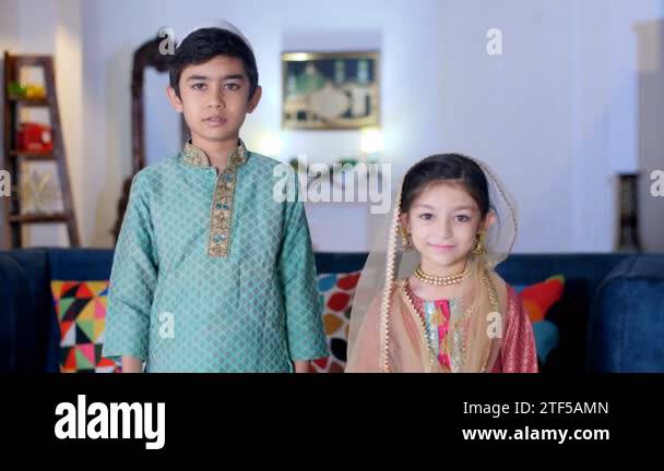 A young Muslim brother-sister doing a Salaam-Alaikum gesture - hello by ...