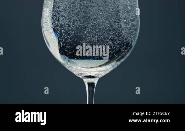 Air bubbles rising cup surface closeup. Pure refreshing water in ...