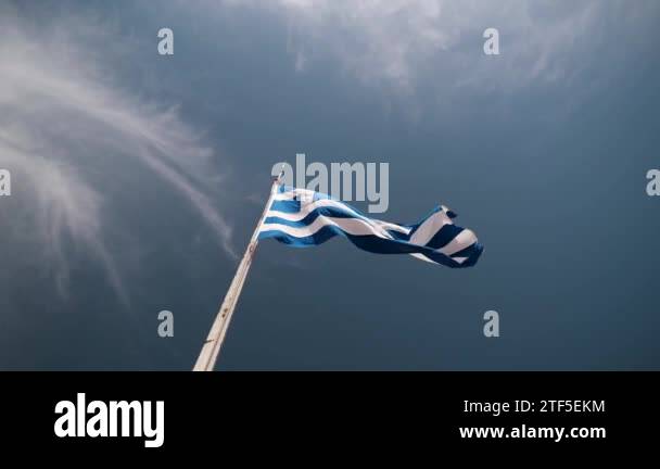 Close-up of the Greek flag waving proudly in slow motion under a bright ...