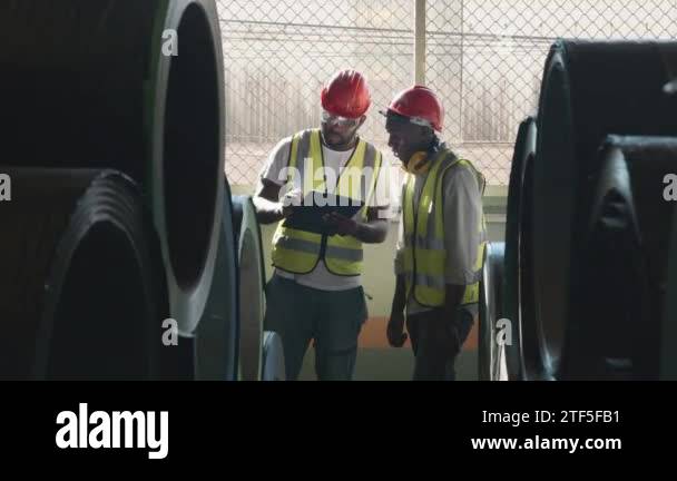 Engineer two worker man African black marking inspection on roll metal ...