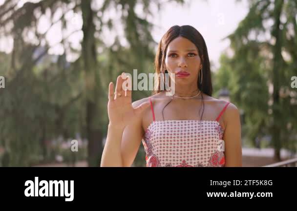 Transgender woman gesturing while extending the hand in stop sign with ...