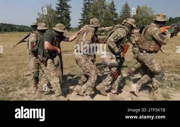 In the battlefield, a group of soldiers with weapons and ammunition is ...