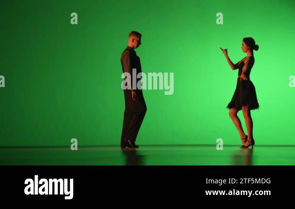 Passionate young woman beckons her partner and they begin to dance an ...