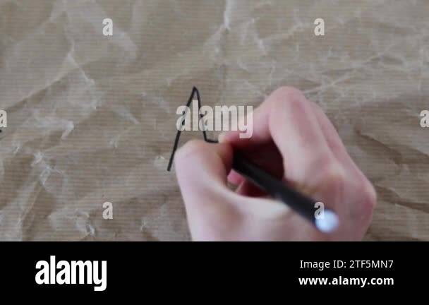 Human handwriting Greek letters alpha and omega on a crumpled paper ...