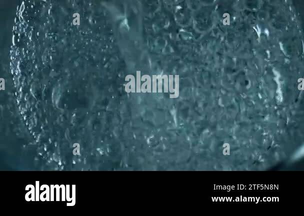 Bubbling water pouring glass top view. Closeup air bubbles rising ...