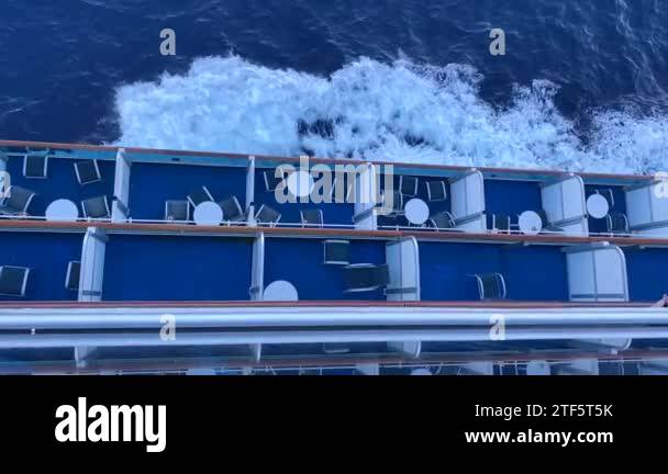 Cruise ship port side balconies and ship's wake. Unusual view looking ...