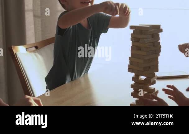 Small Kids Children playing tiny jenga with her parents at table, jenga ...