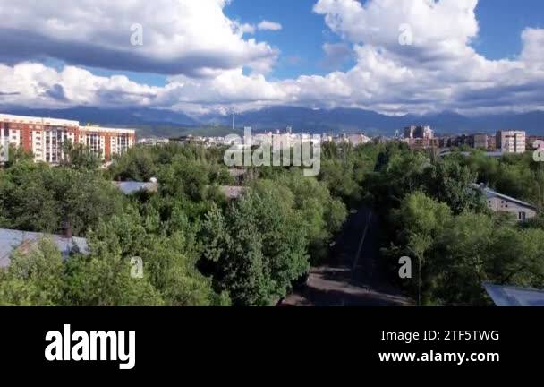 Landscape of Almaty city and mountains with clouds. Cumulus clouds over ...