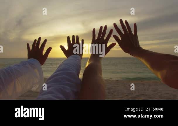 Happy family. Group of people stretch their hands to sun. Teamwork of ...