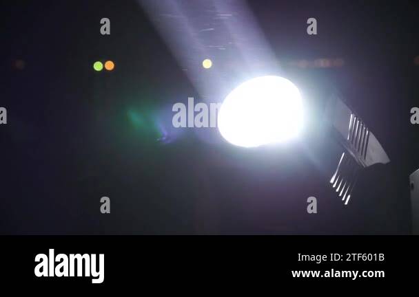 Spotlight machines create light beams with moving its direction in the ...