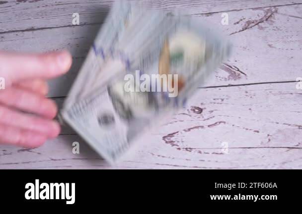 Female Hands Throwing a Stack of 100 Dollar Bills on the Table. Zoom ...